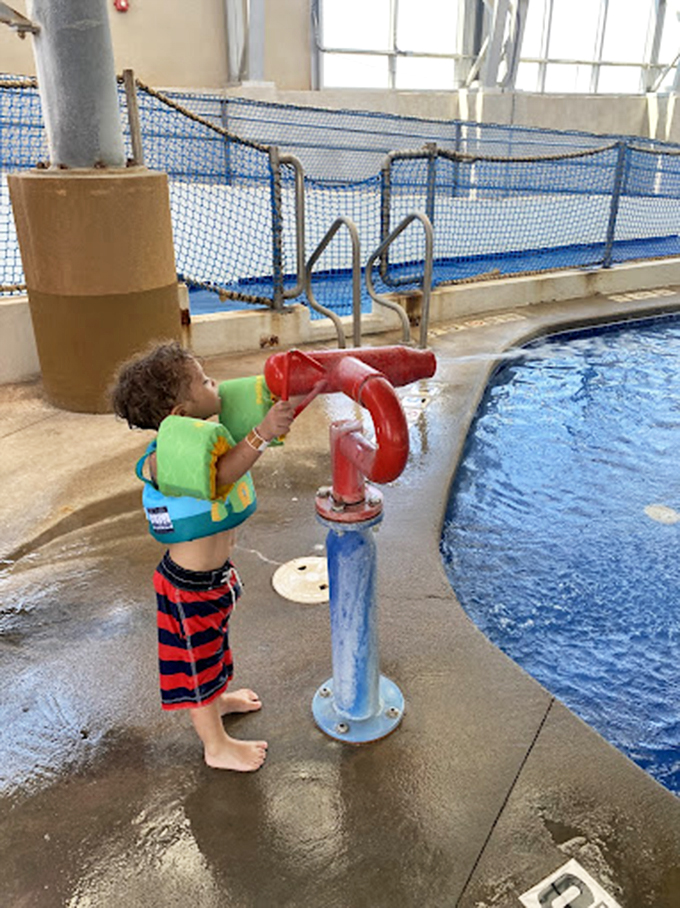 Junior firefighter training or water park fun? Why not both! This little guy's mastering the art of aquatic marksmanship one splash at a time.