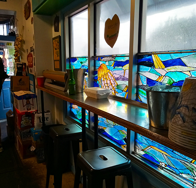 Stained glass windows filter light like underwater sunbeams, creating the perfect ambiance for seafood feasting without getting wet.