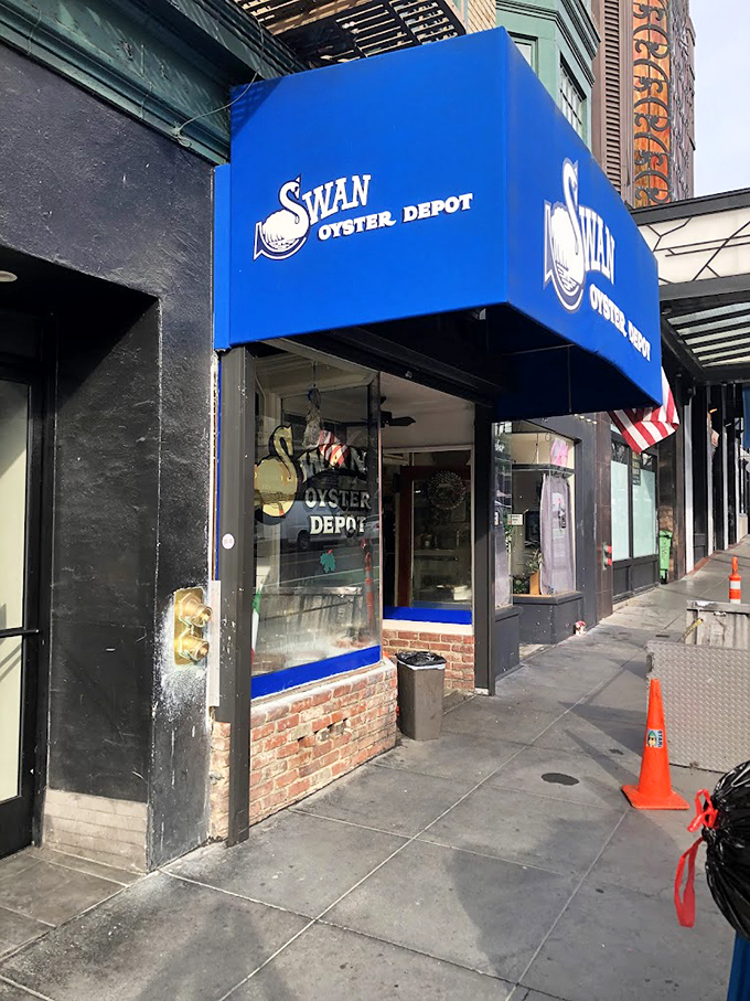 Swan Oyster Depot's bright blue awning stands out like a maritime flag signaling "Fresh seafood ahead!"