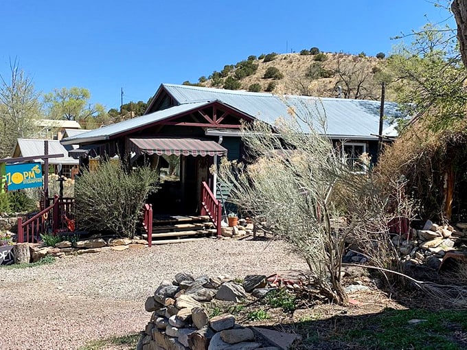Desert landscaping frames this welcoming shop entrance, where sage and stone create a quintessentially New Mexican welcome mat.