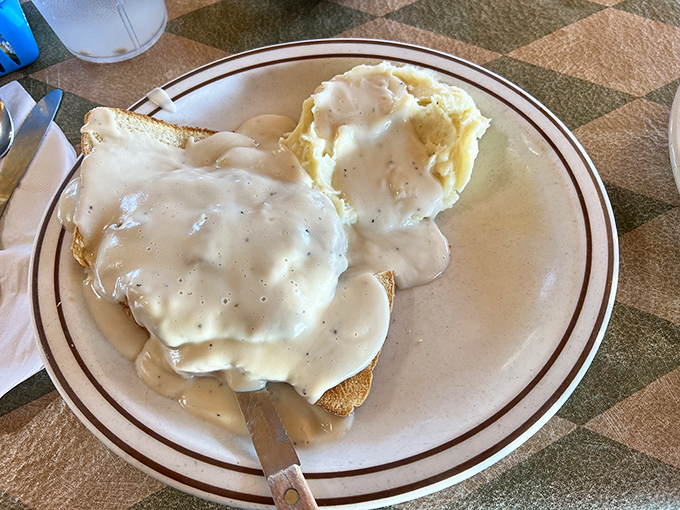 Biscuits swimming in creamy gravy isn't just breakfast&mdash;it's edible therapy. That knife isn't for cutting; it's for ensuring not a drop escapes your plate.