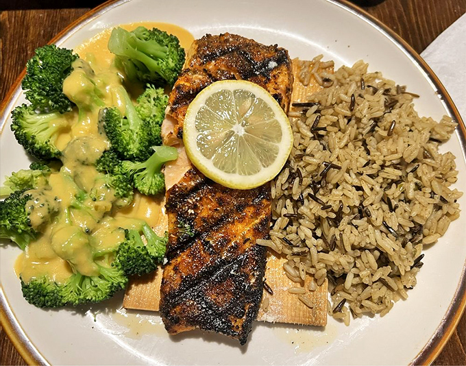 Blackened cedar plank salmon that's having a better day than you are. Perfectly cooked fish meets wild rice and broccoli in a plate that screams "adulting done deliciously."
