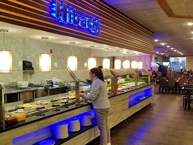 The hibachi station glows blue like an underwater kingdom. Those plates stacked below are about to embark on journeys of delicious destiny.