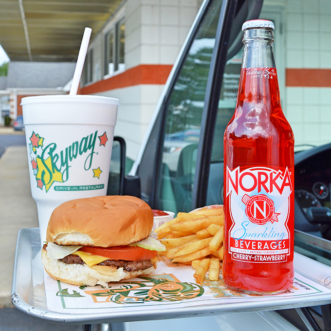 The holy trinity of drive-in perfection: a classic burger, crispy fries, and a cherry-strawberry Norka soda. This is what contentment looks like.
