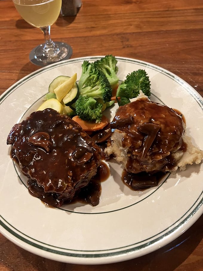 Meatloaf smothered in rich gravy alongside fresh vegetables&mdash;the kind of plate that makes you want to hug whoever's in the kitchen.