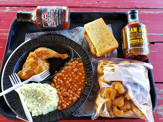 A barbecue spread worthy of a celebration, complete with chicken, sides, and sauce bottles standing by like eager backup dancers.