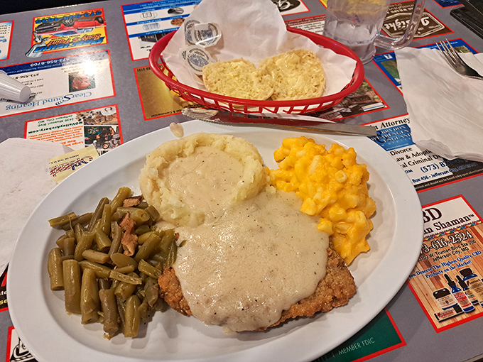 Country-fried redemption on a plate—crispy coating, creamy gravy, and sides that understand their supporting role perfectly.