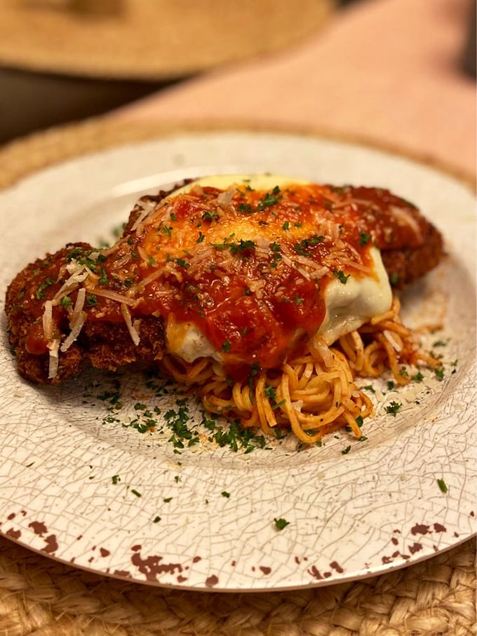 Chicken parmesan that's been breaded, fried, and sauced to perfection. That crispy coating holding court with tangy marinara is pure culinary theater.