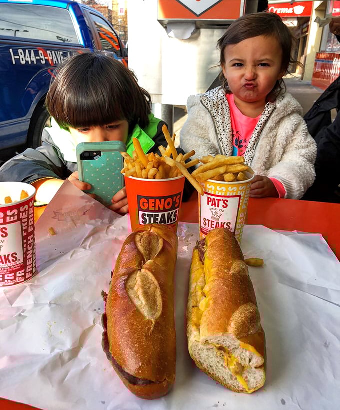 The ultimate taste test in progress! Two generations experiencing the great cheesesteak debate&mdash;Pat's vs. Geno's&mdash;in one epic meal.
