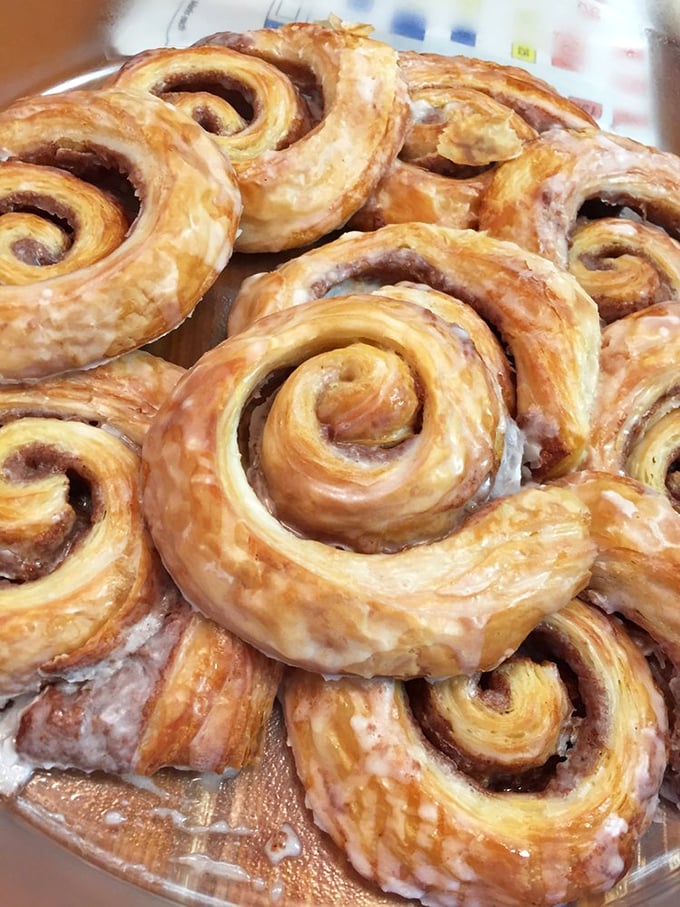 These cinnamon rolls aren't just baked; they're lovingly crafted spiral galaxies of sweetness that somehow improve conversation just by being on the table.