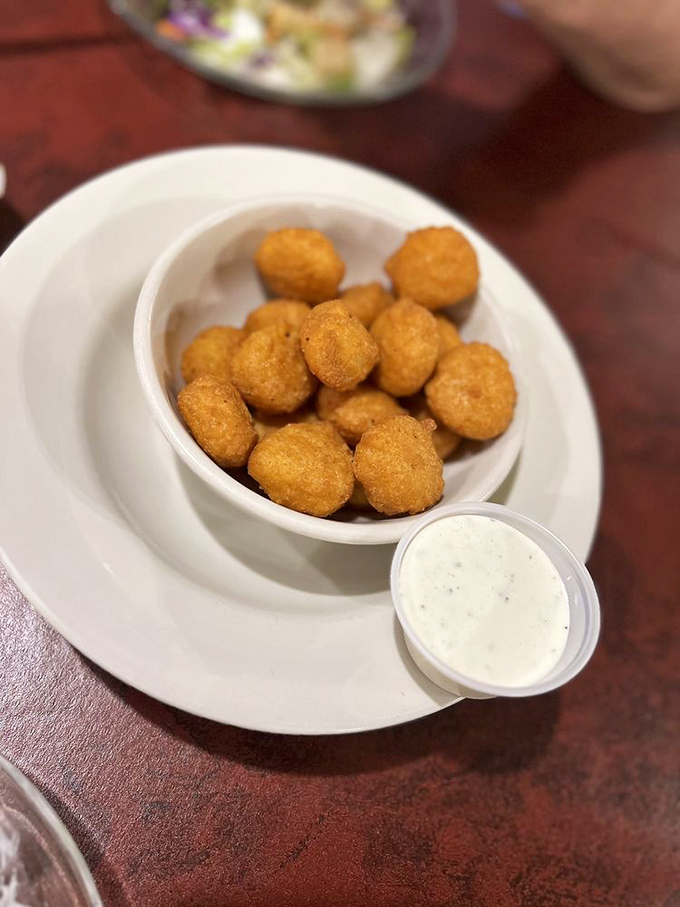 Golden orbs of cornmeal happiness, like little ambassadors of the Midwest saying "Howdy" to your taste buds.