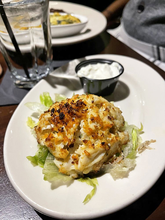 A crab cake with the perfect sear—crispy exterior giving way to sweet crab meat, like nature's version of a savory crème brûlée.