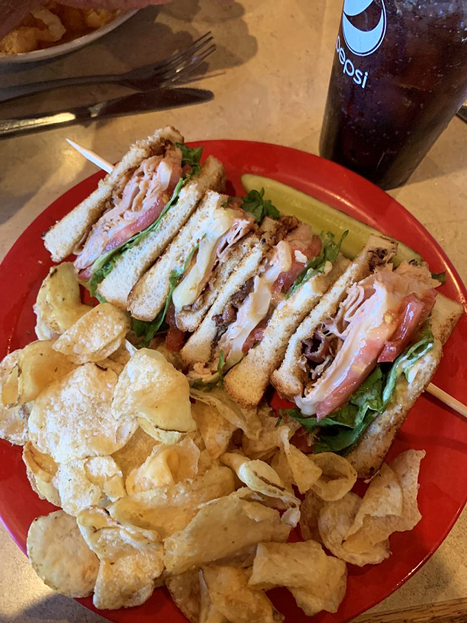 This club sandwich, stacked higher than my last credit card bill, comes with enough chips to satisfy that primal craving for all things crunchy.