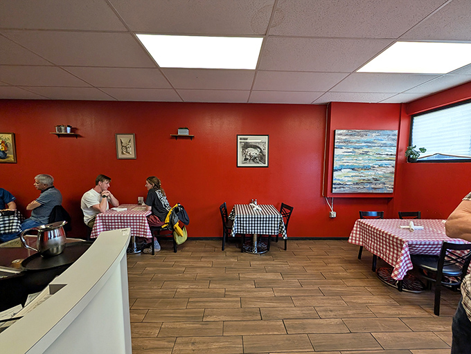 Simple framed art adorns walls the color of marinara. No distractions here&mdash;just the perfect backdrop for the real art that arrives on your plate.