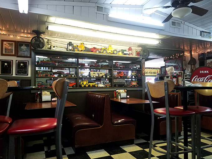 Toy trucks line the shelves above burgundy booths, creating a dining space that feels like it was decorated by your coolest grandpa.