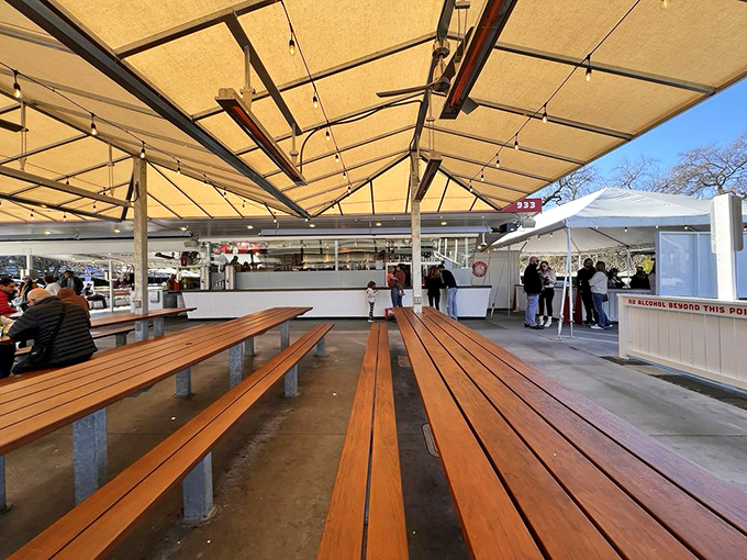 Wooden benches under canvas shade&mdash;where strangers become temporary friends united by the universal language of "mmmmm."