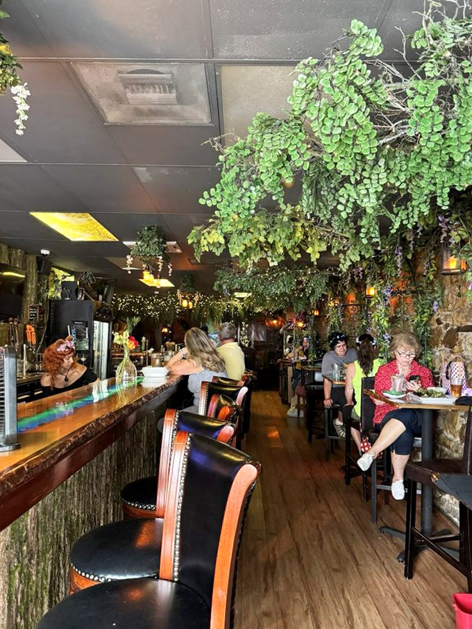 Diners bask in the dappled light of the indoor forest, momentarily transformed into characters in their own fairy tale.