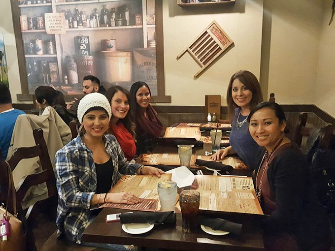 Happy diners gathered around wooden tables&mdash;creating memories that will last longer than the food coma that follows.