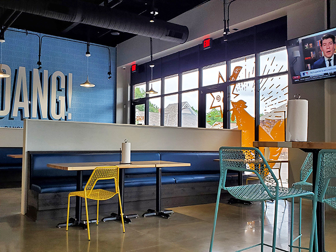 "HOT DANG!" proclaims the wall, and the dining area agrees. Blue banquettes and colorful chairs create a space that's as lively as the food.