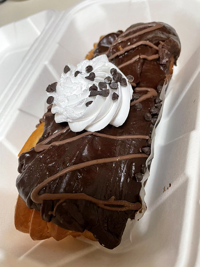 This &eacute;clair isn't just dessert&mdash;it's therapy with chocolate frosting. The whipped cream dollop is the chef's way of saying "You deserve this."
