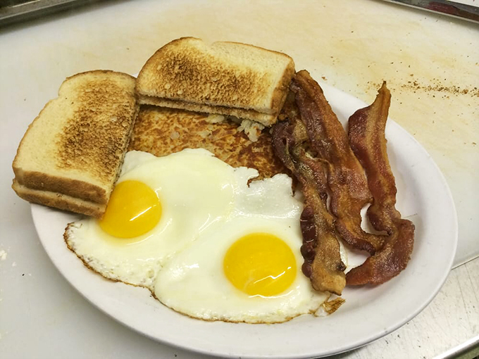 The breakfast trifecta&mdash;sunny-side-up eggs, perfectly crisped bacon, and toast&mdash;simple perfection that never goes out of style.