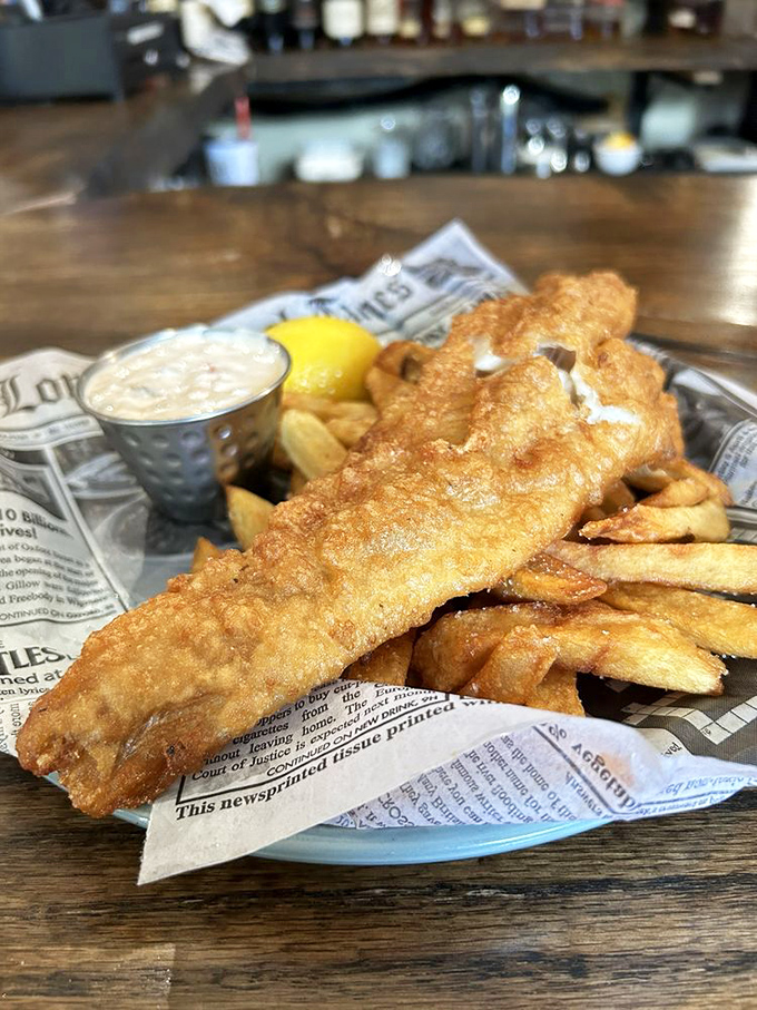 Fish and chips served on newspaper—a crispy, golden reminder that sometimes the simplest foods are the hardest to perfect.