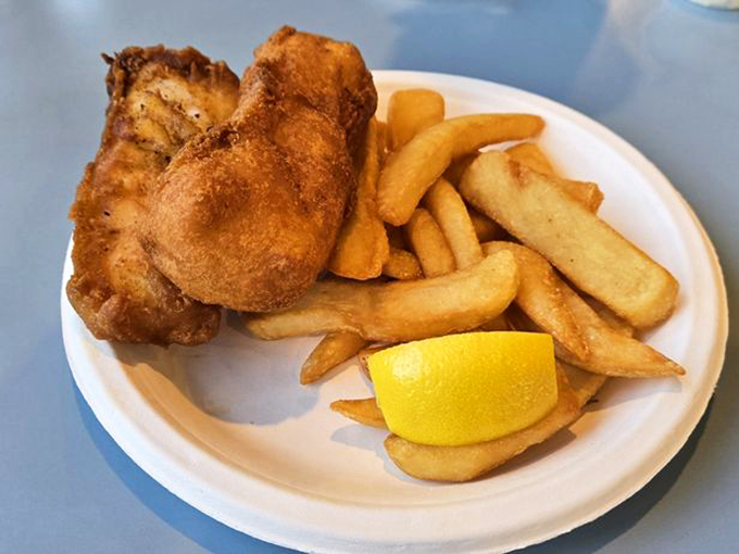 Classic fish and chips that would make a British pub jealous. That lemon wedge isn't decoration&mdash;it's the finishing touch on perfection.