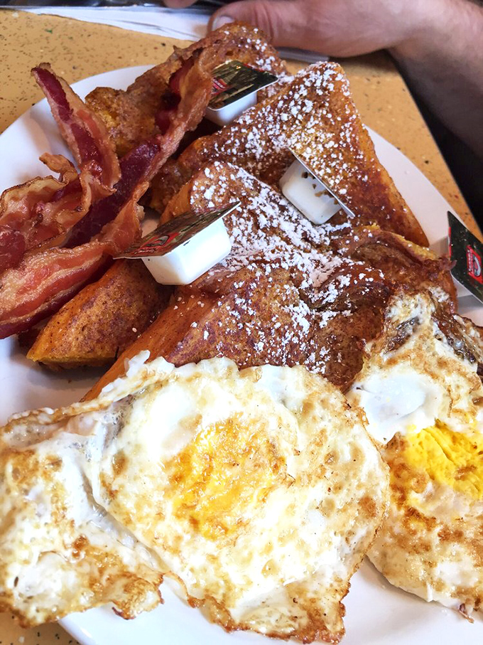 French toast that's dressed for success, dusted with powdered sugar and flanked by eggs that know exactly how important this breakfast moment is.