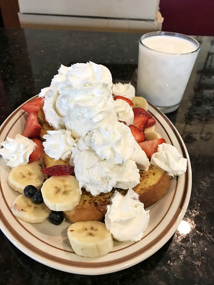 French toast that's dressed for success. Crowned with whipped cream and surrounded by a fruit security detail, it's breakfast royalty.