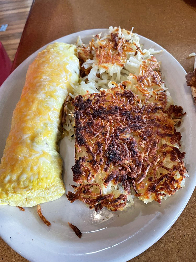Breakfast perfection: a fluffy omelet that's practically glowing with cheese alongside hash browns that achieved the ideal crisp-to-tender ratio.