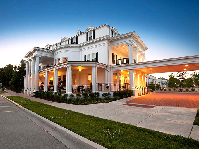 The Historic Boone Tavern Hotel glows at dusk, its white columns and warm lights beckoning travelers like a Southern mansion saying "Y'all come in now."