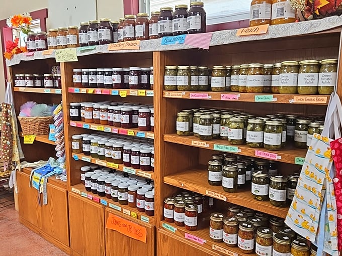 A wall of homemade preserves showcases the seasons captured in glass. Each jar tells the story of summer's bounty saved for winter's table.