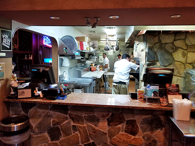 Behind the scenes where dough becomes dreams. The open kitchen isn't just transparency&mdash;it's dinner and a show.