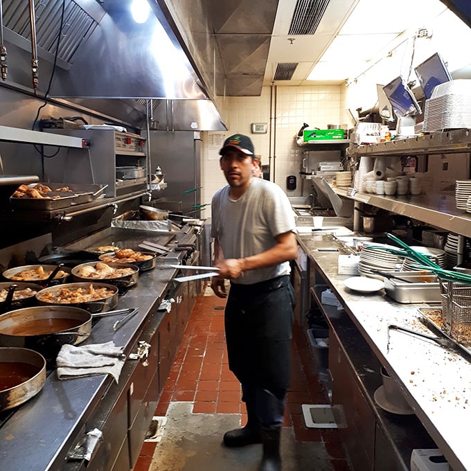 Where the magic happens – cast iron skillets lined up like soldiers, ready to transform ordinary chicken into extraordinary memories.