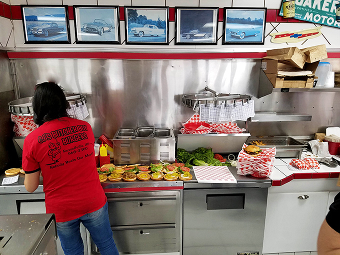 Behind the scenes magic where burger dreams come true&mdash;vintage car photos watching over the assembly line of happiness.