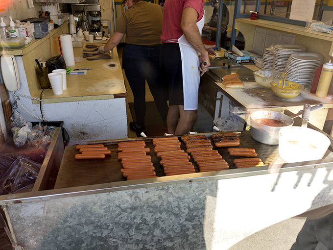 Hot dog alchemy in action. The sacred grill where ordinary becomes extraordinary through the magic of heat and tradition. 