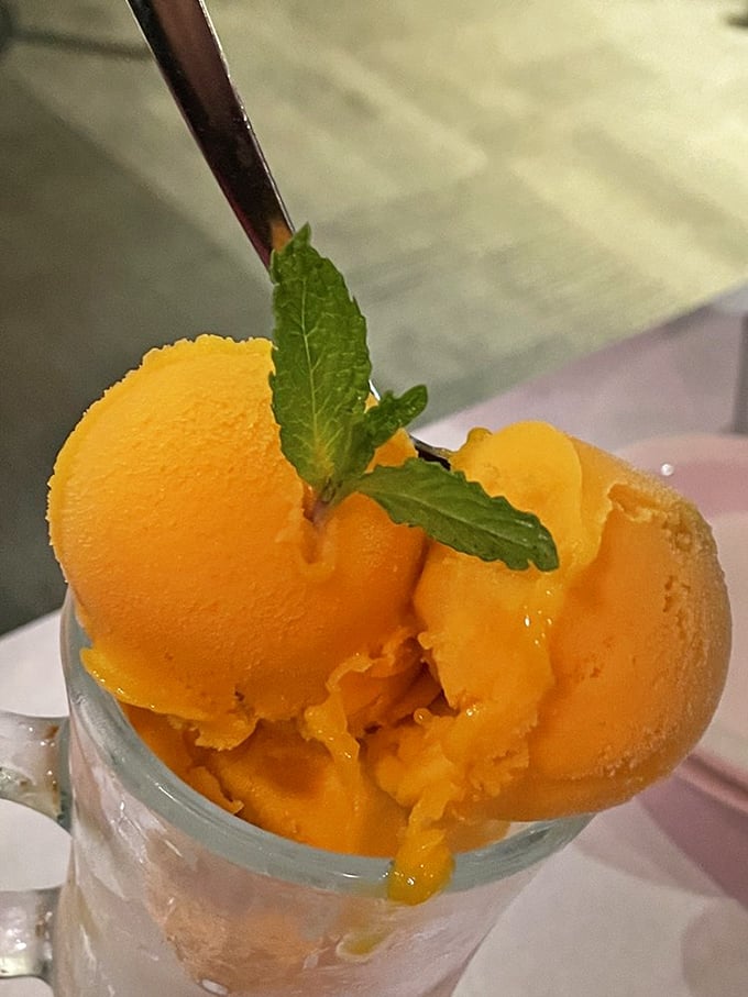 Mango sorbet that captures sunshine in frozen form. The mint garnish isn't just pretty&mdash;it's the exclamation point at the end of a sweet sentence.