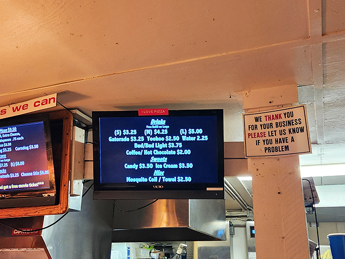 The digital menu board – where reasonable prices make you wonder if you've somehow traveled back to 1995. Those mosquito coils are pure Florida drive-in wisdom.