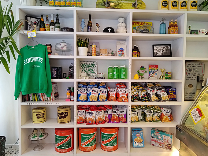 The merchandise wall doubles as a nostalgic snack museum, showcasing childhood favorites alongside Middle Child's branded swag.