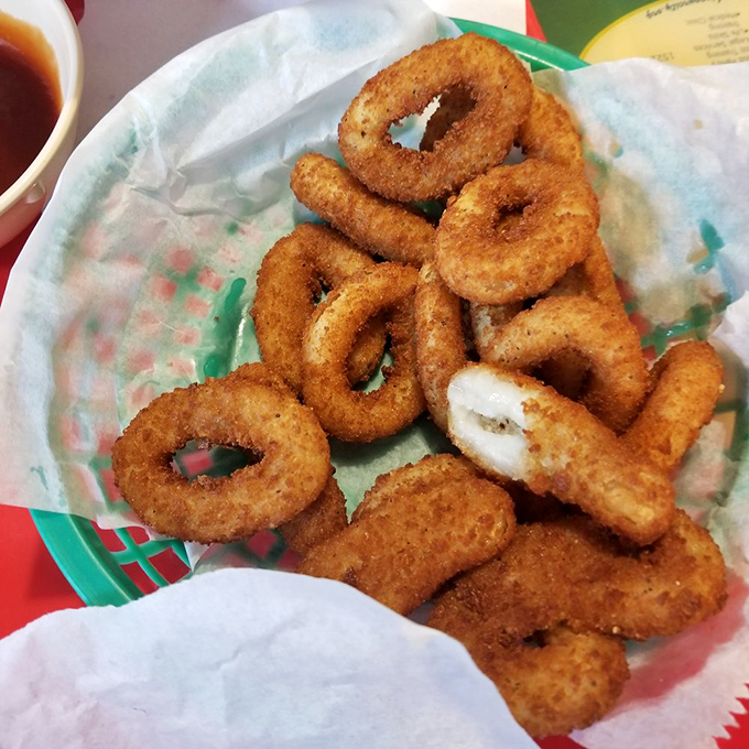 Onion rings that shatter with a satisfying crunch, nestled in paper like the precious deep-fried treasures they truly are.