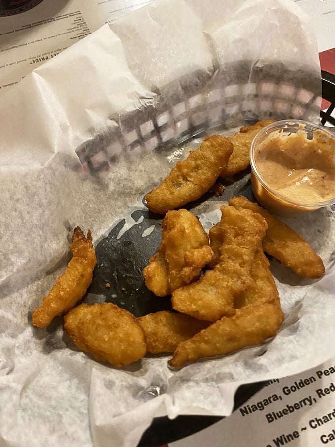 Golden-fried onion petals that shatter with each bite, paired with a dipping sauce that makes you wonder why you'd ever eat onions any other way.