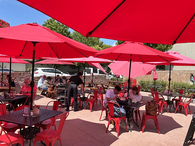 Al fresco dining under cherry-red umbrellas&mdash;California sunshine with a side of pancakes. Breakfast with vitamin D benefits.