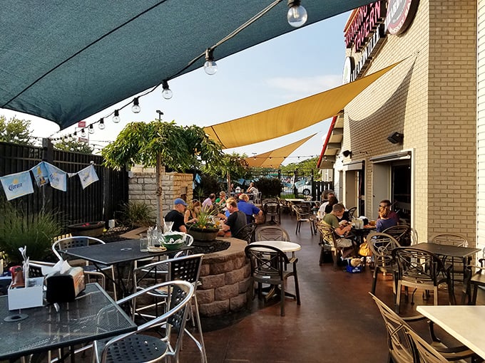 The patio: where summer evenings stretch into night and strangers become friends over shared sauce recommendations.