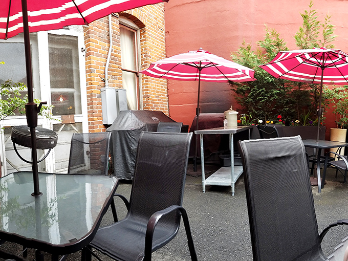 Outdoor seating with bright red umbrellas offers a splash of color against brick walls&mdash;the perfect spot for breakfast with a side of people-watching. 