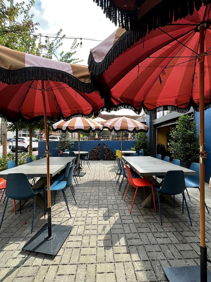 Outdoor dining under circus-bright umbrellas—because sunshine and good food have always been natural partners in the happiness business.