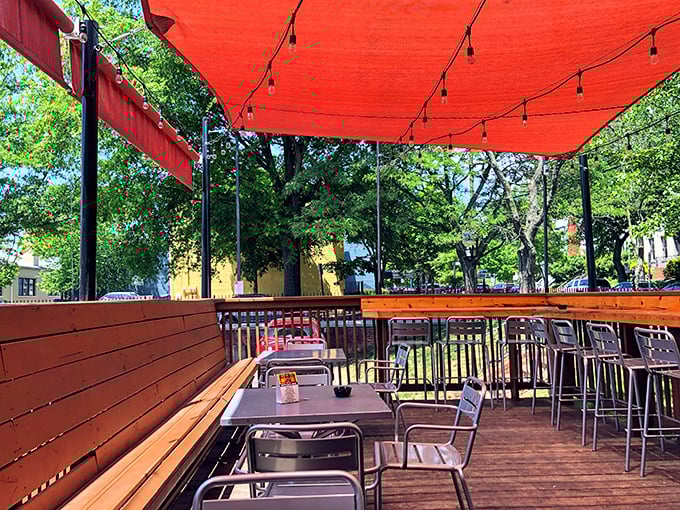 The outdoor patio at City Dogs offers dining al fresco beneath string lights &ndash; nature's way of saying "this hot dog deserves atmospheric lighting."