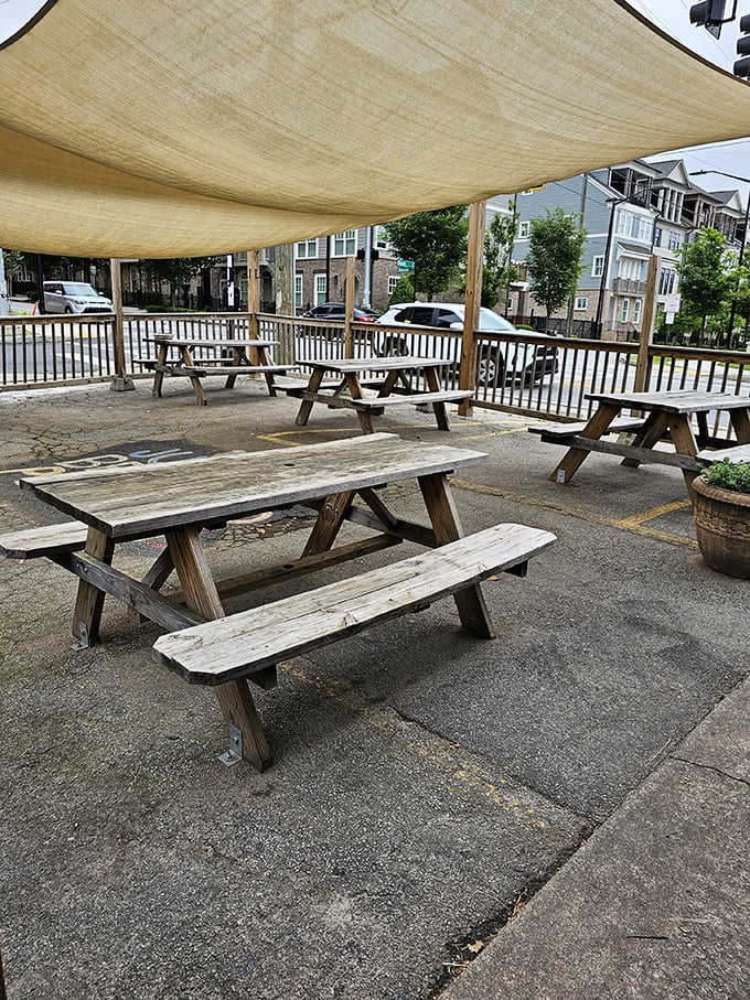 The outdoor seating area provides a shaded respite for recovery after your breakfast conquest. You might need those picnic tables for a post-meal nap.