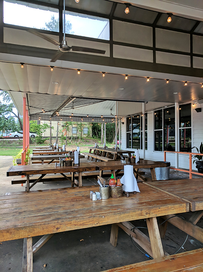 The patio's picnic tables aren't just seating&mdash;they're community builders where strangers become friends over shared barbecue revelations.