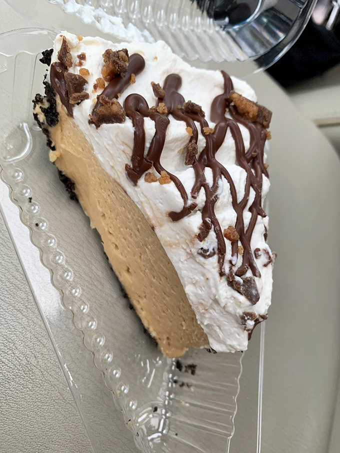 Peanut butter pie crowned with whipped cream and chocolate drizzle&mdash;basically childhood dreams in sophisticated adult form.