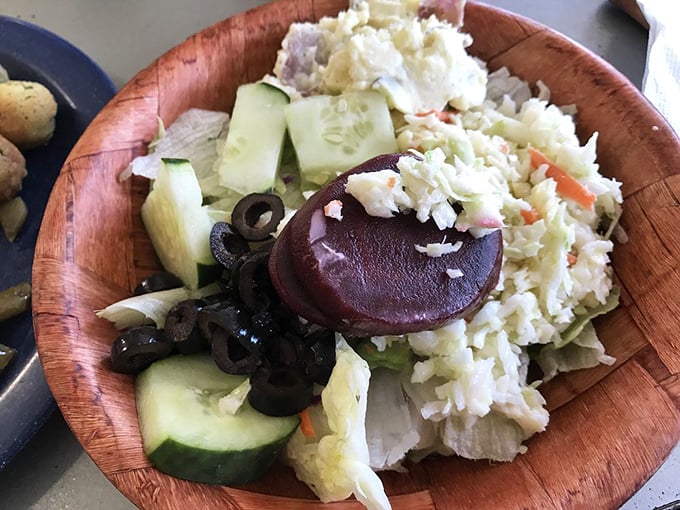 A wooden bowl salad that brings garden-fresh crunch to balance the heartier offerings, proving vegetables can be the star, not the understudy.